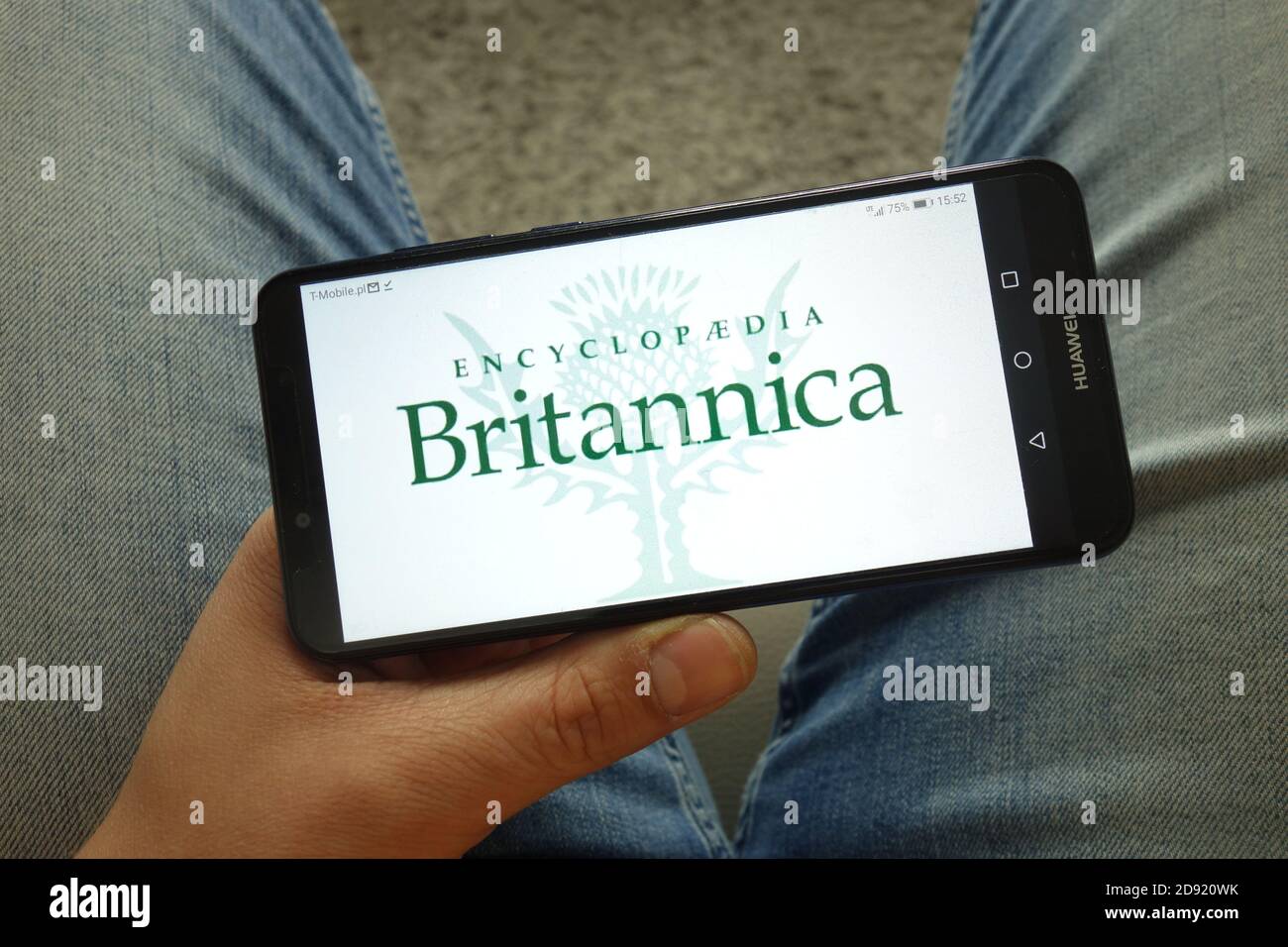 Man holding smartphone with Encyclopedia Britannica logo Stock Photo ...