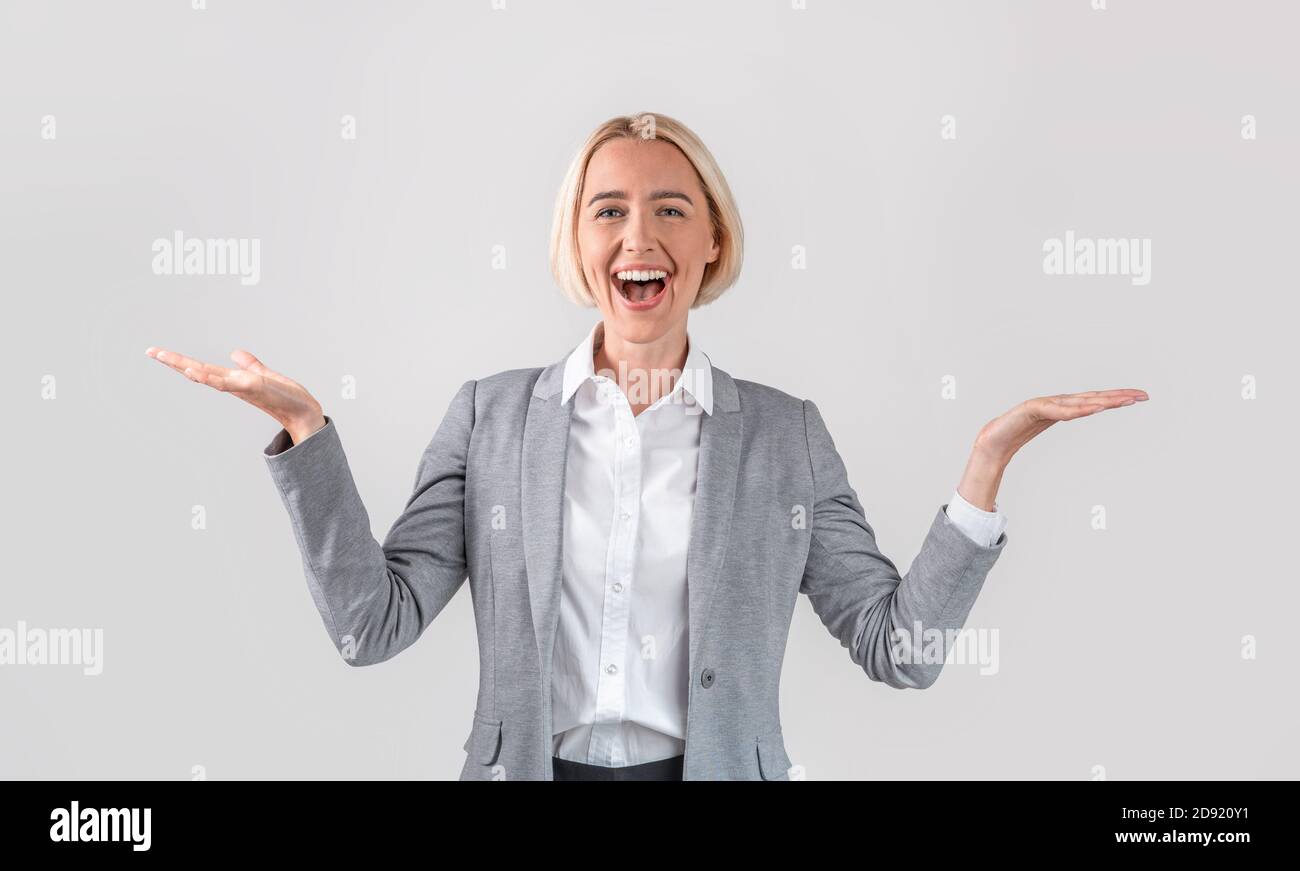 Businesswoman comparing options, making scales, holding invisible ...