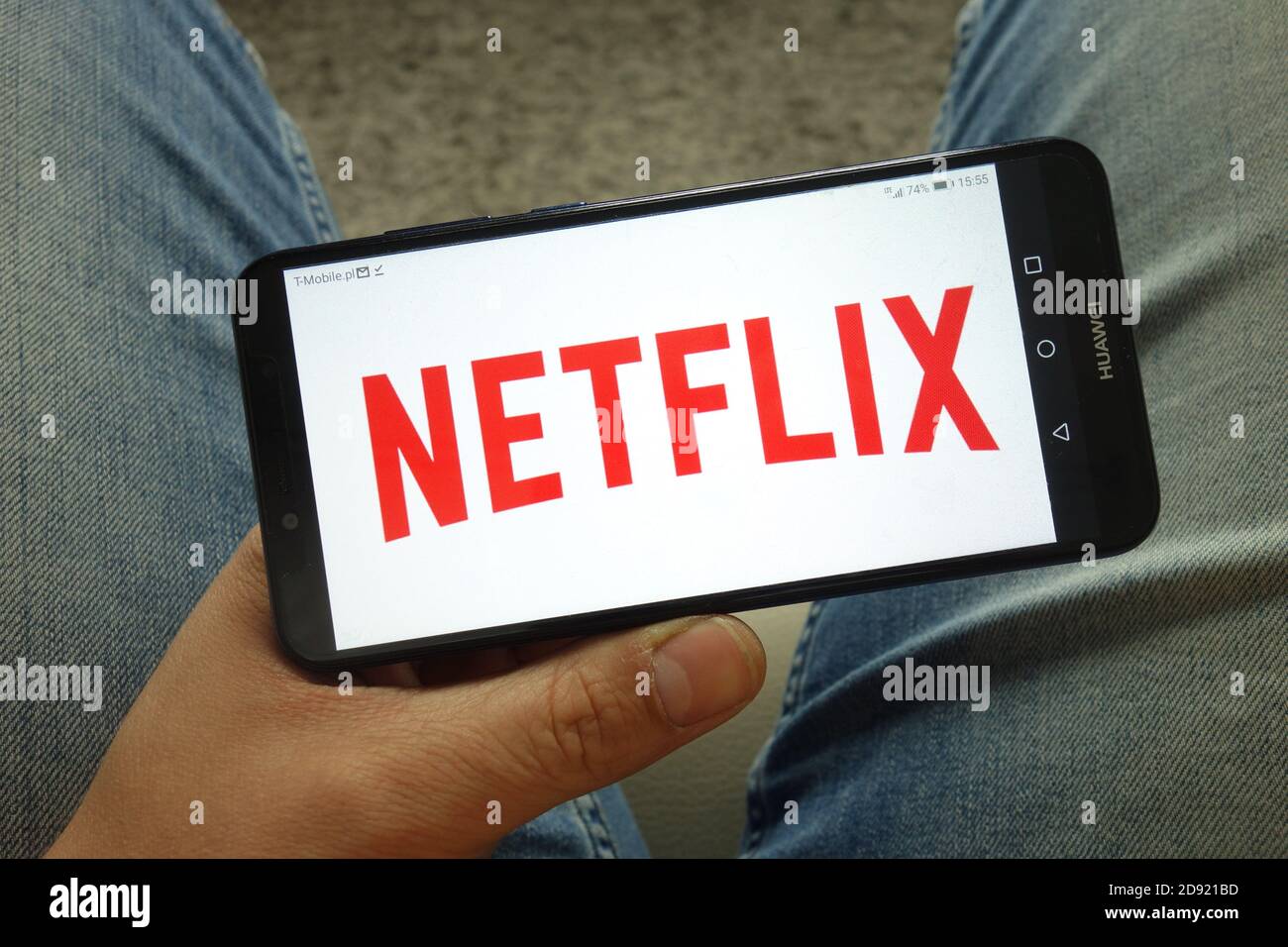 Man holding smartphone with Netflix Inc company logo Stock Photo - Alamy