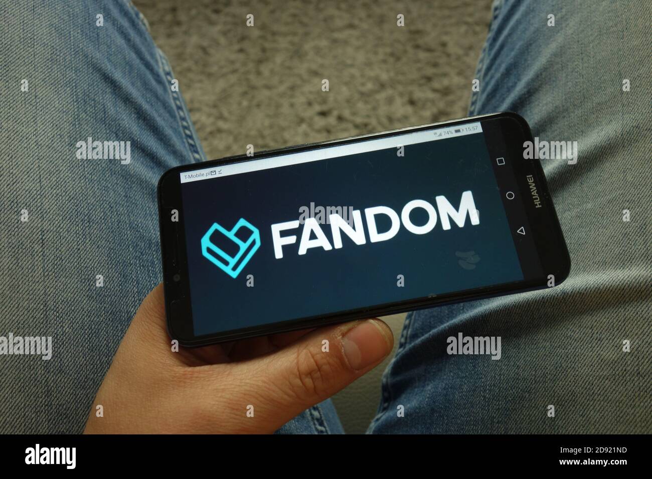 Man holding smartphone with Fandom website logo Stock Photo - Alamy