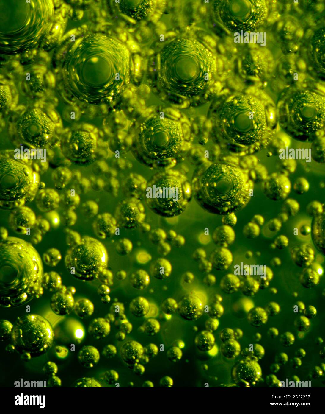 Different sized metallic green balls flying in space Stock Photo - Alamy