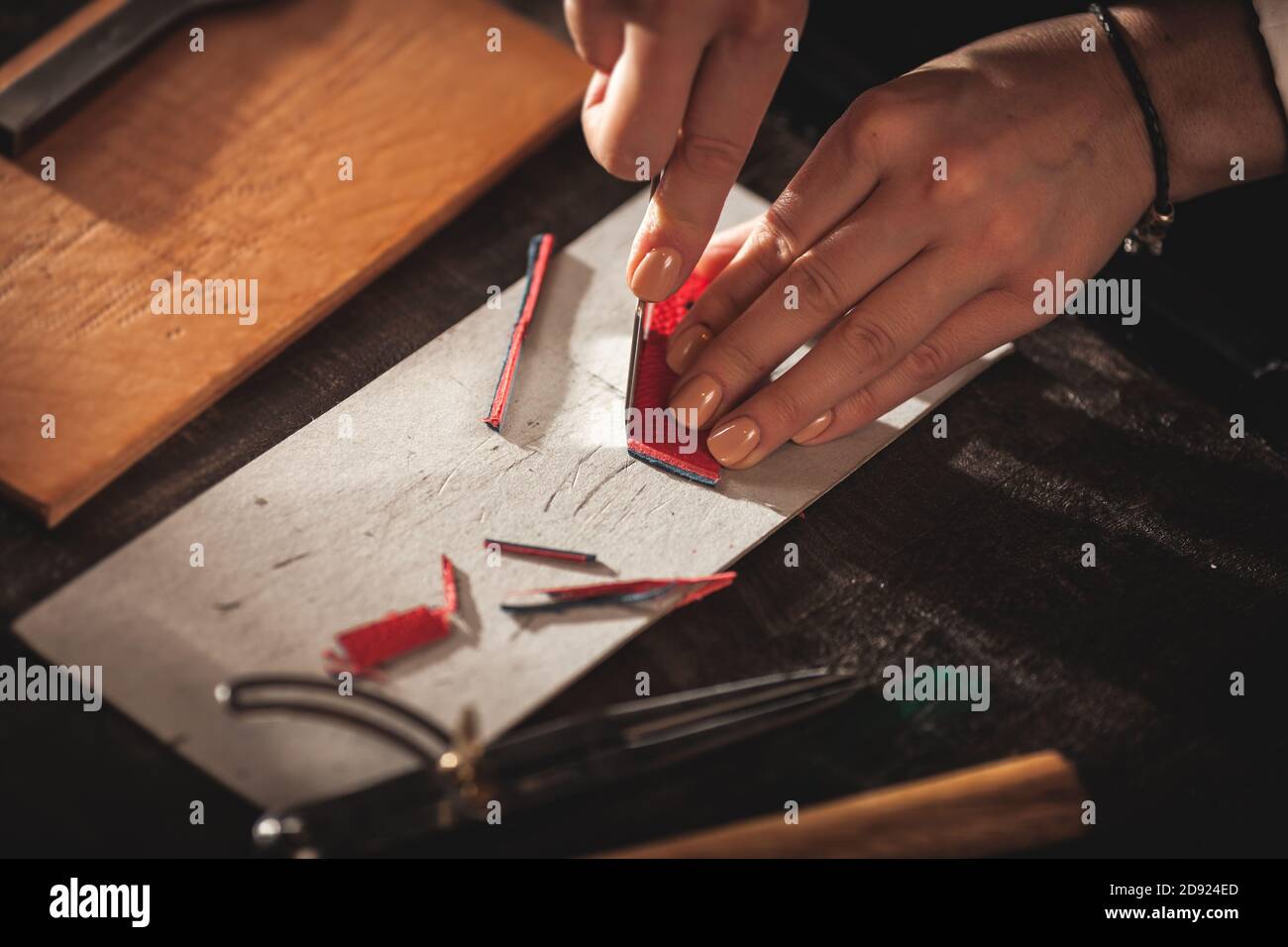 Leather handbag craftsman at work in a vintage workshop. Small business ...