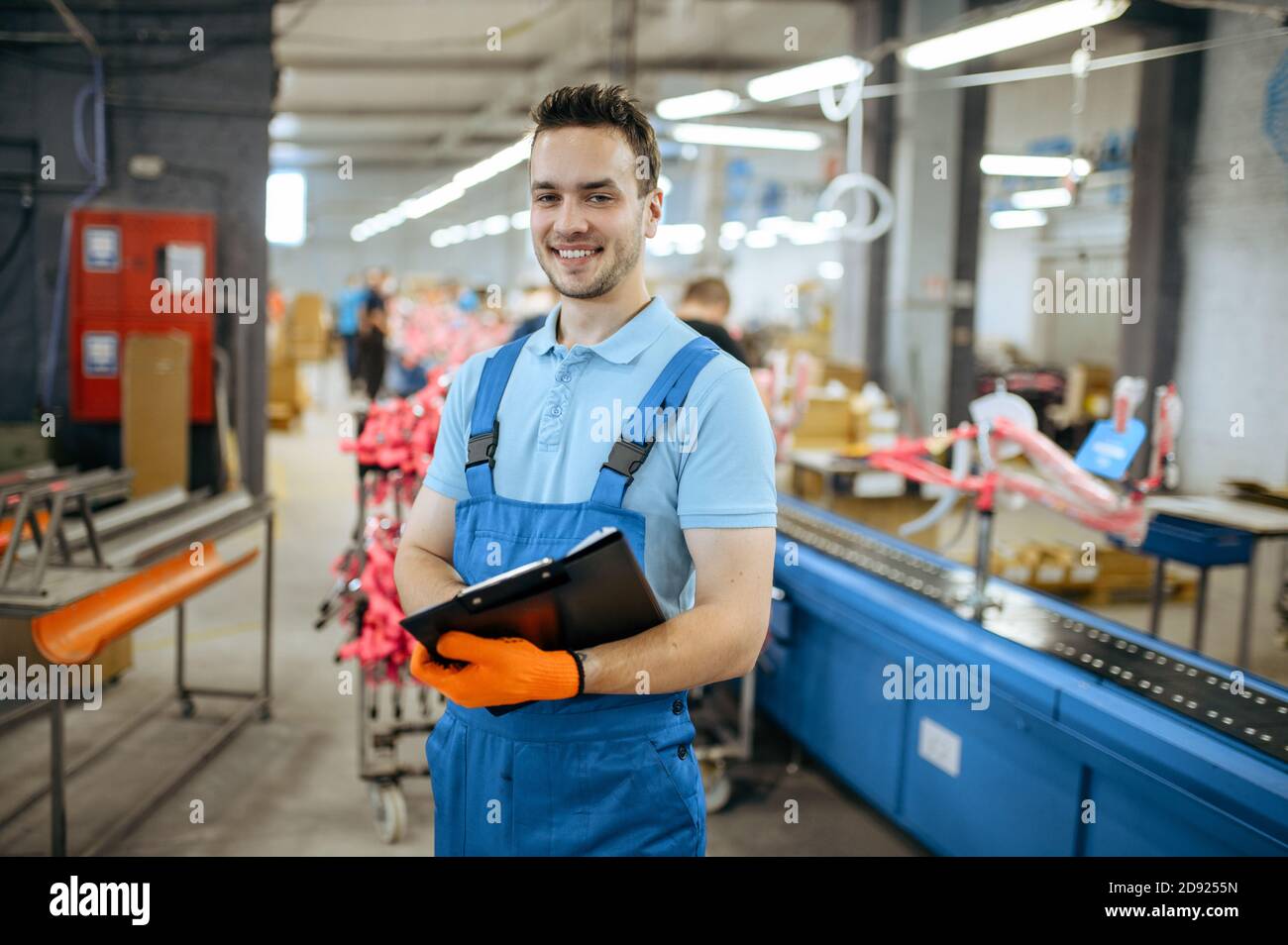 Bicycle factory, smiling worker at assembly line Stock Photo - Alamy