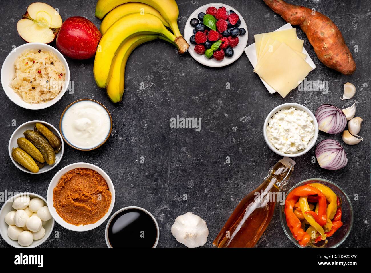 Top view of variety probiotic and prebiotic foods on black background ...