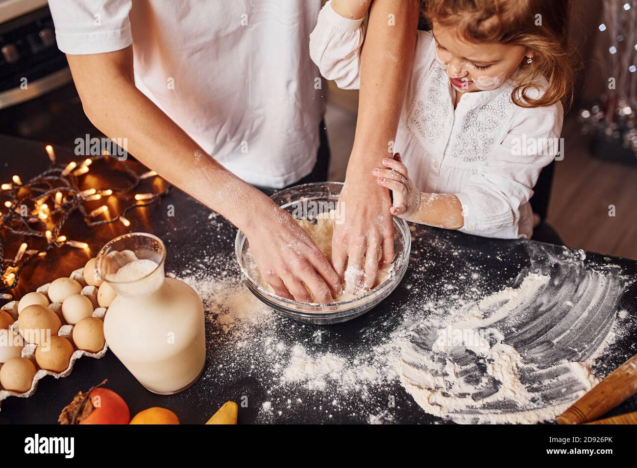 Close up view of brother with his little sister that preparing food on ...