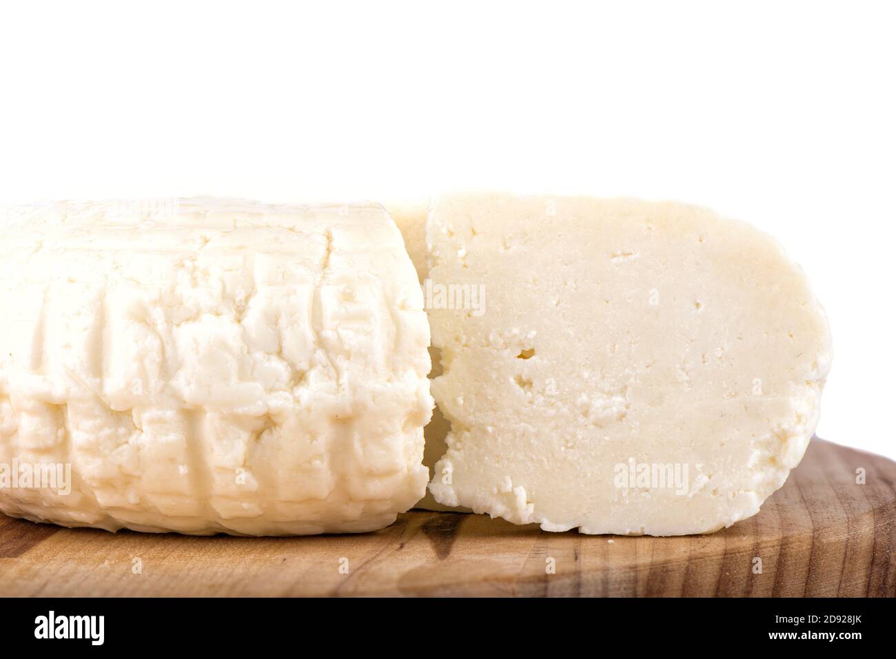 Close-up of a cut of soft cheese on a cutting board. Food background ...