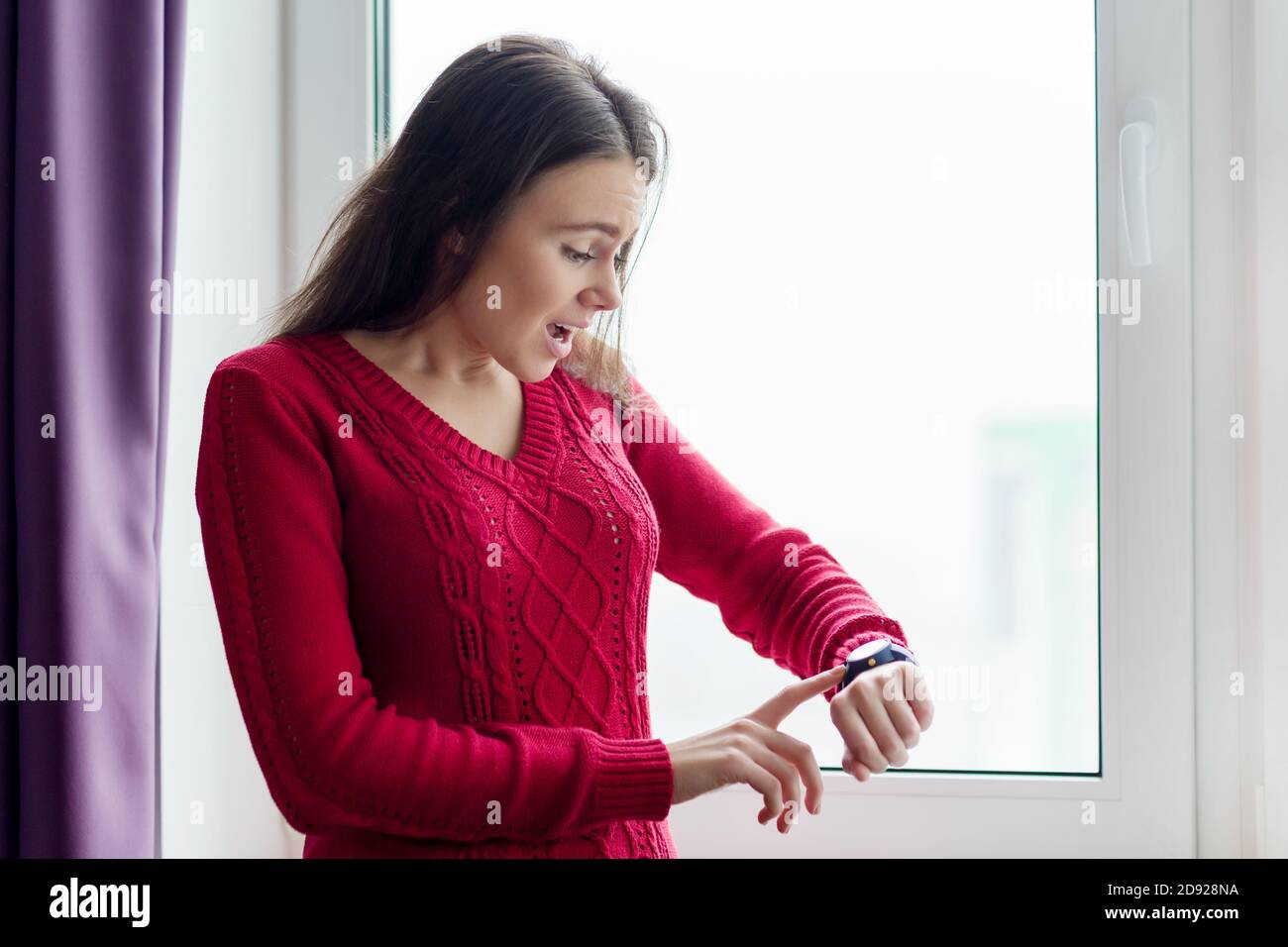 Woman checking clock office hi-res stock photography and images - Alamy