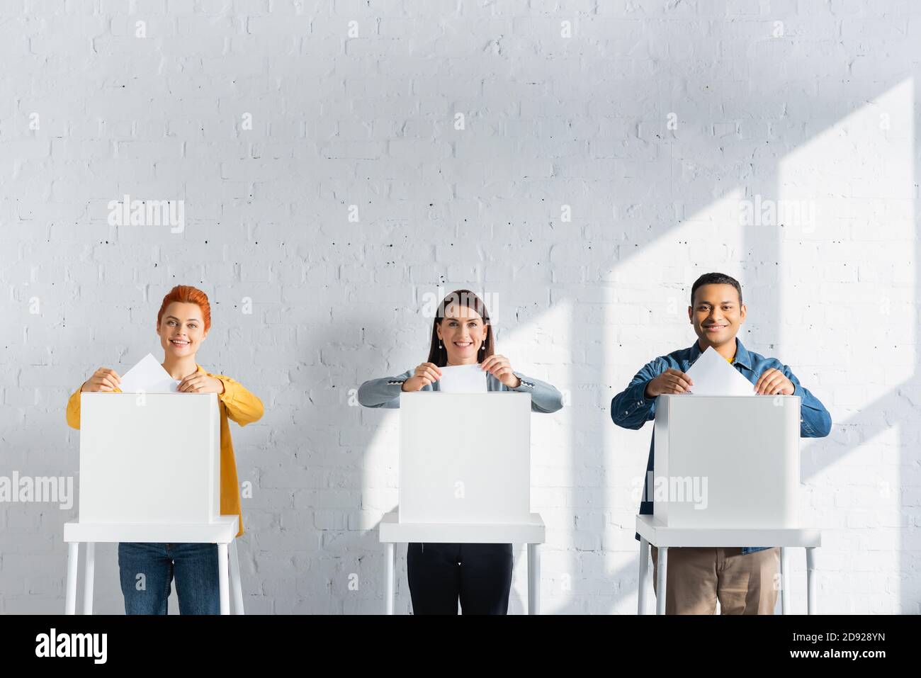 multicultural voters inserting ballots into polling boxes against white ...