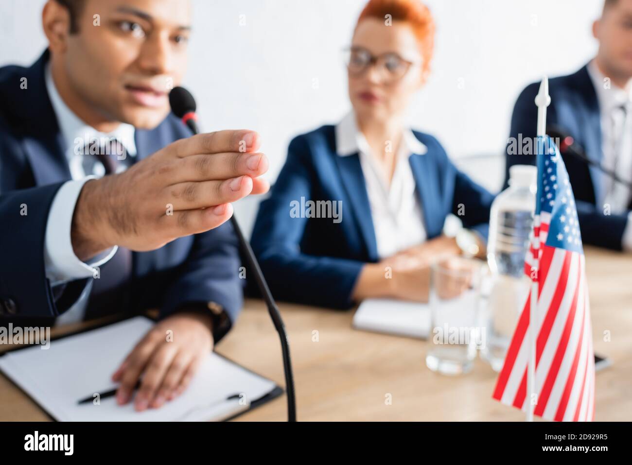 Indian politician pointing with hand, while speaking in microphone ...