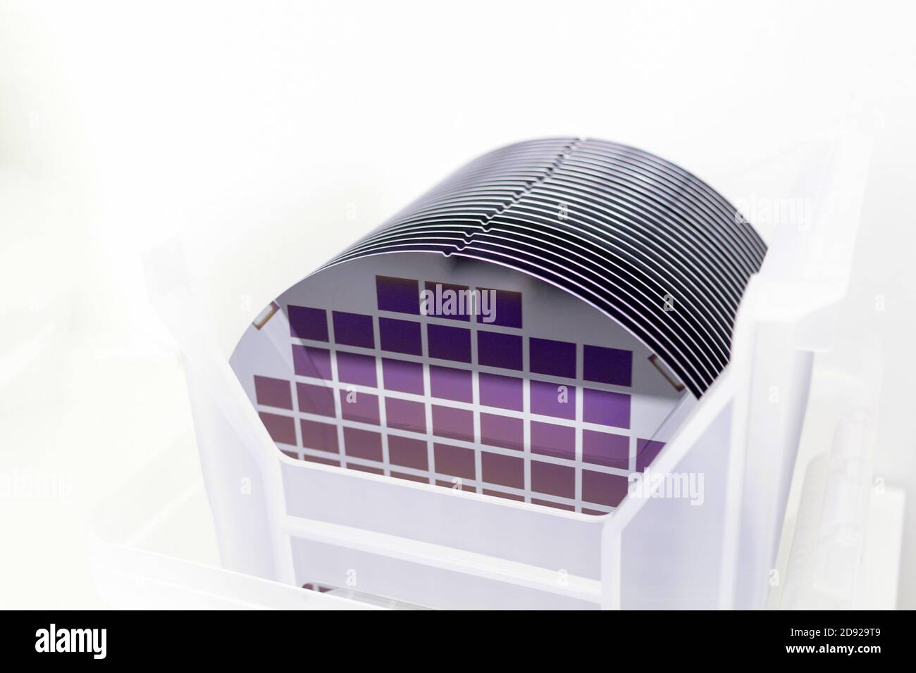 Silicon Wafers in white plastic holder box on a table- A wafer is a ...