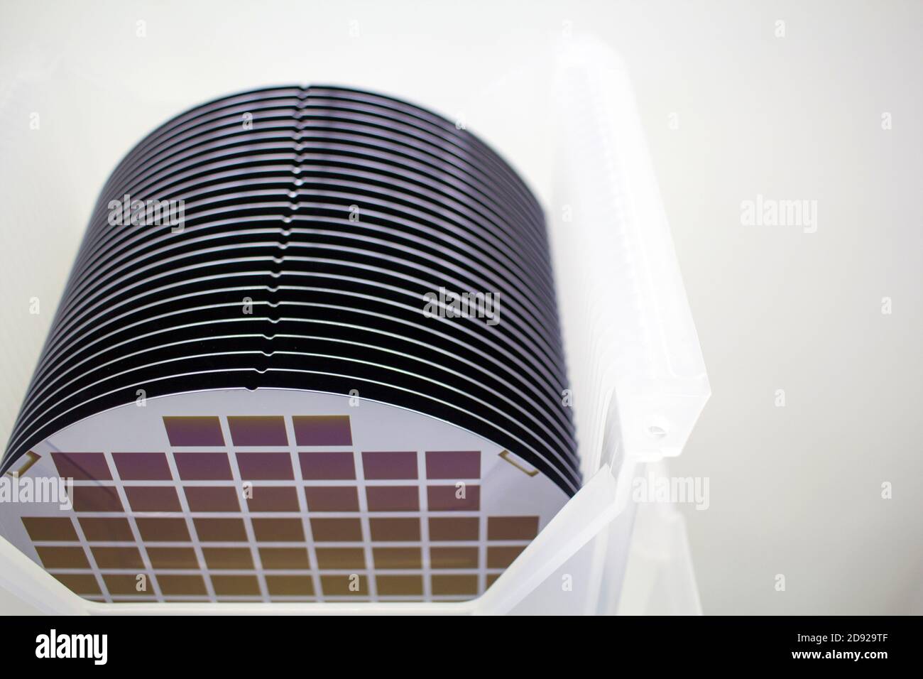 Silicon Wafers in white plastic holder box on a table- A wafer is a ...
