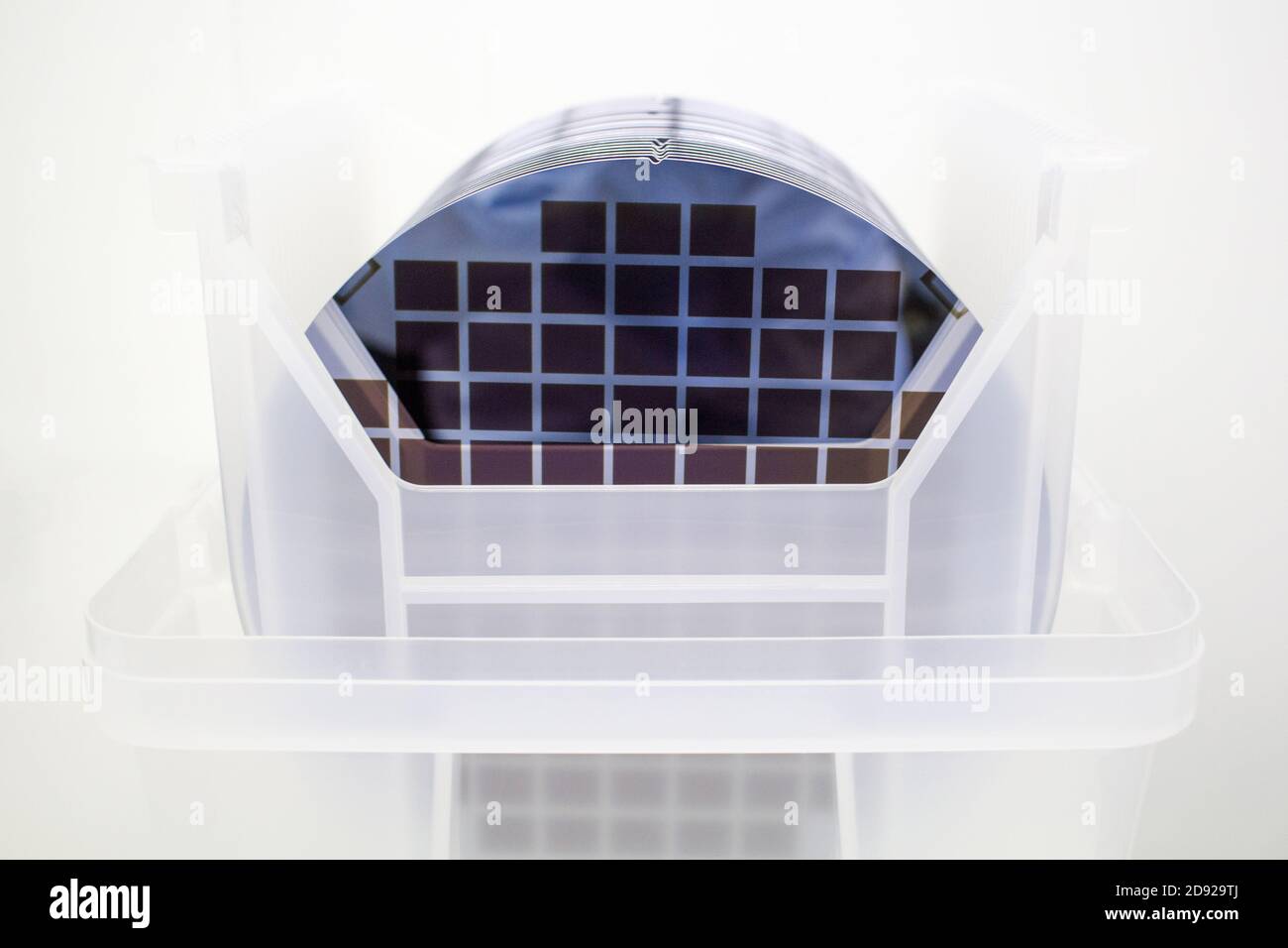 Silicon Wafers in white plastic holder box on a table- A wafer is a ...