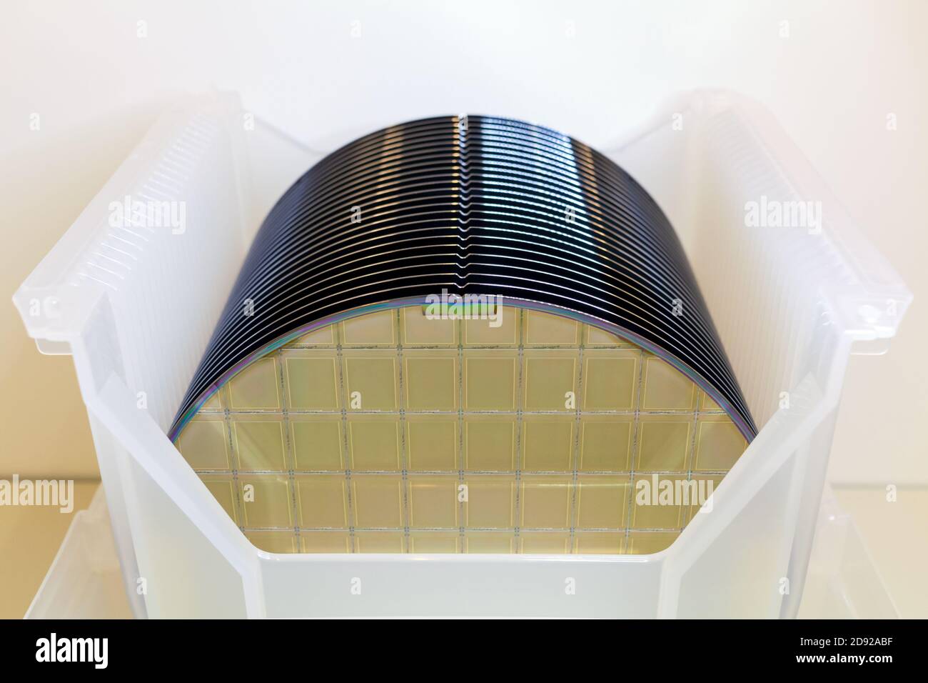 Silicon Wafers in white plastic holder box on a table- A wafer is a ...