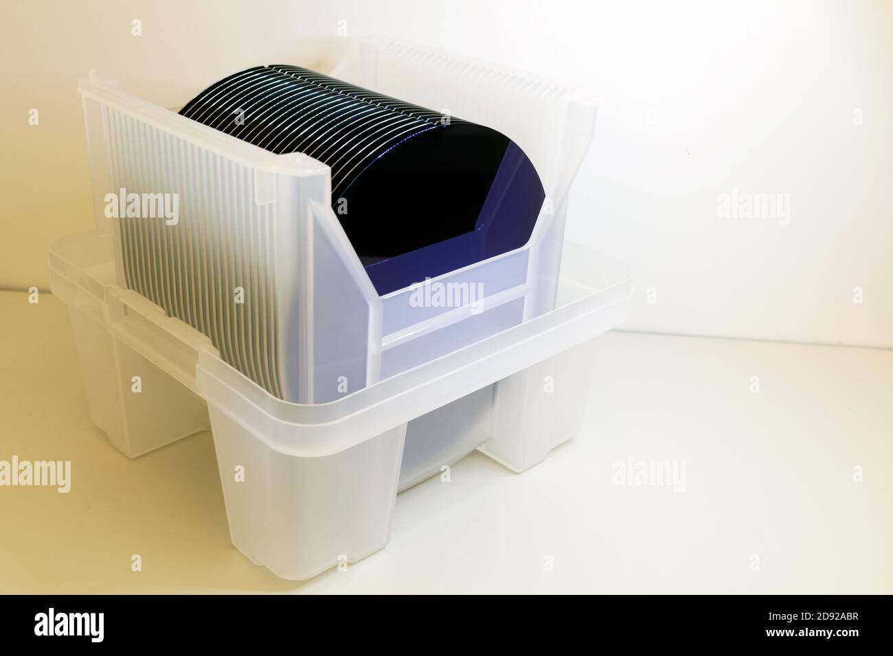 Silicon Wafers in white plastic holder box on a table- A wafer is a ...