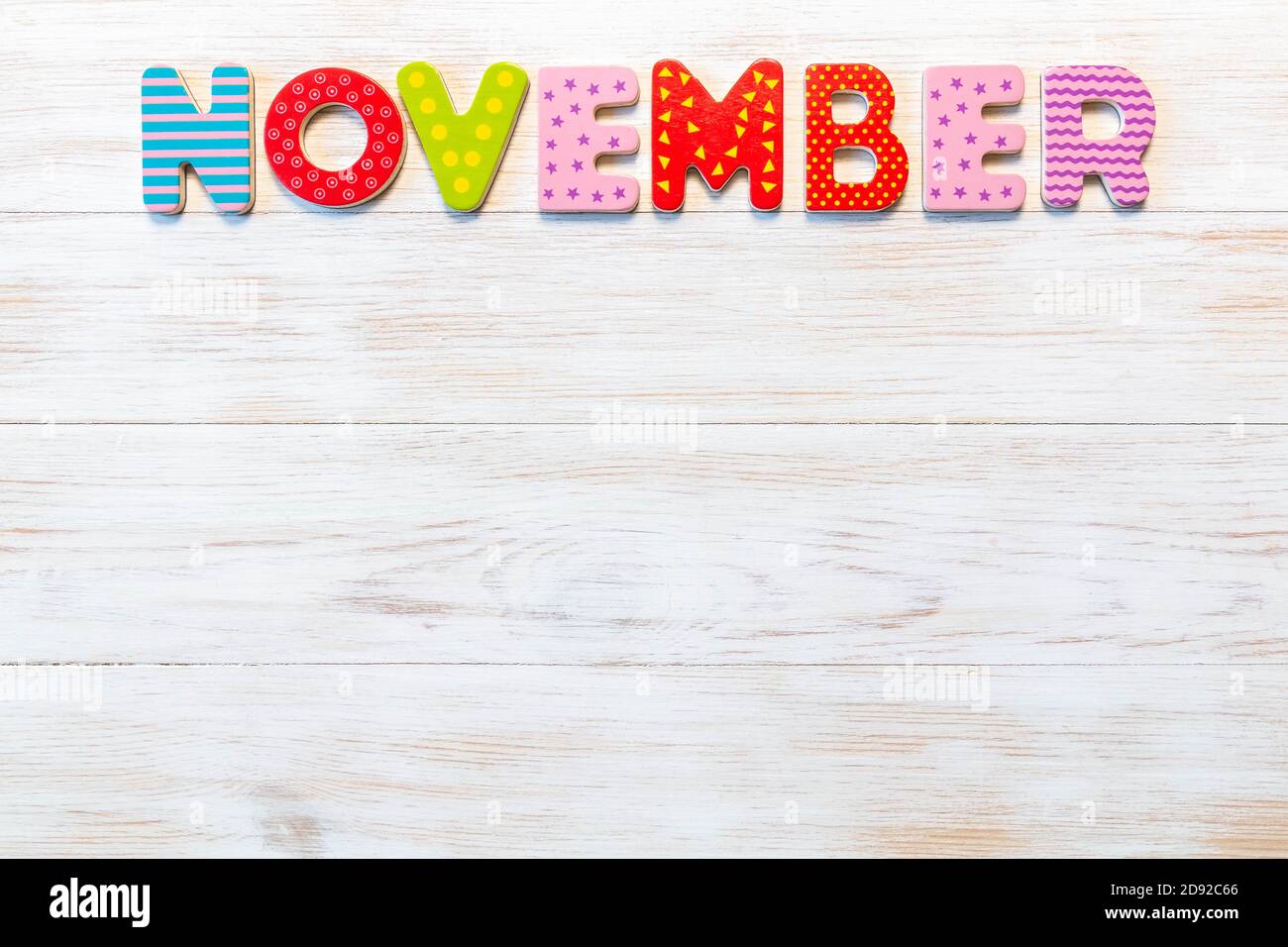 Wooden letters written November month on vintage background ...
