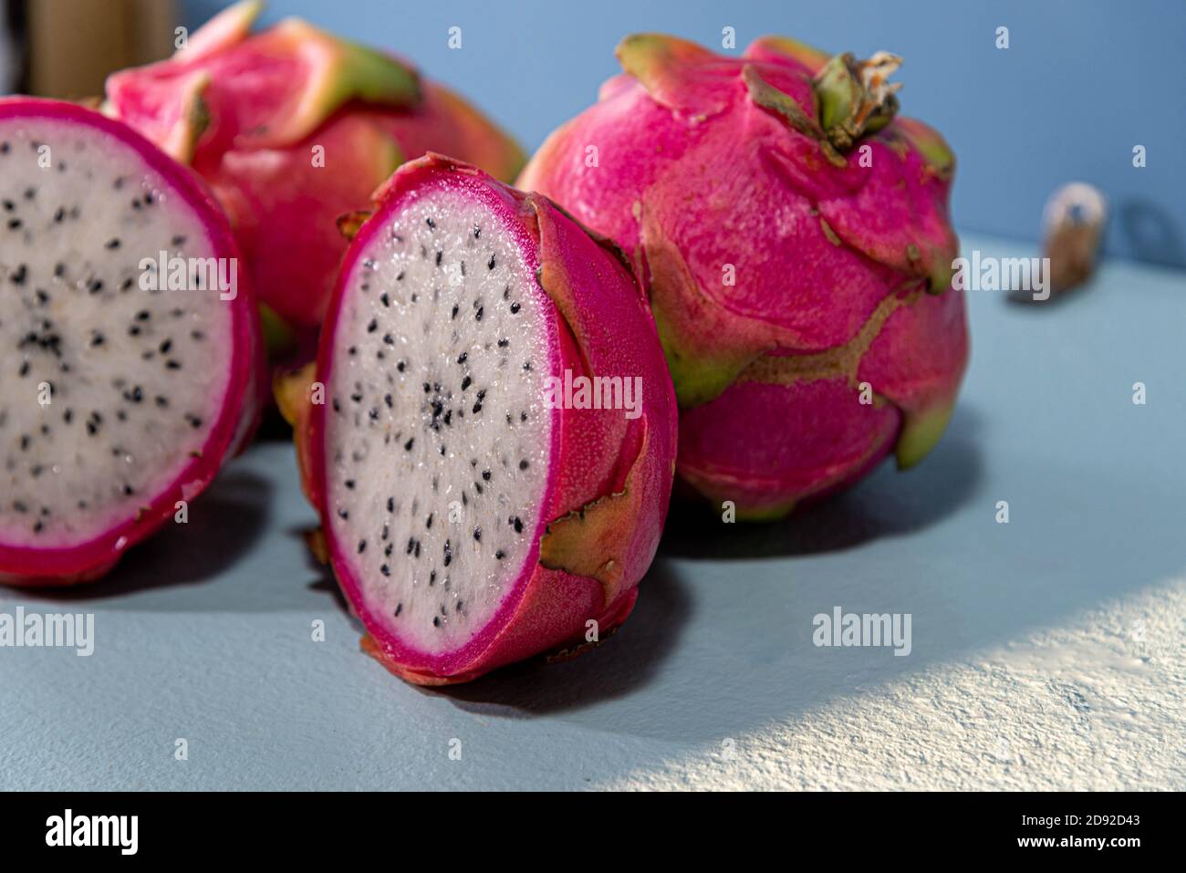 Pitaya fruits. Dragon fruit in halves. Blue background. Natural and ...