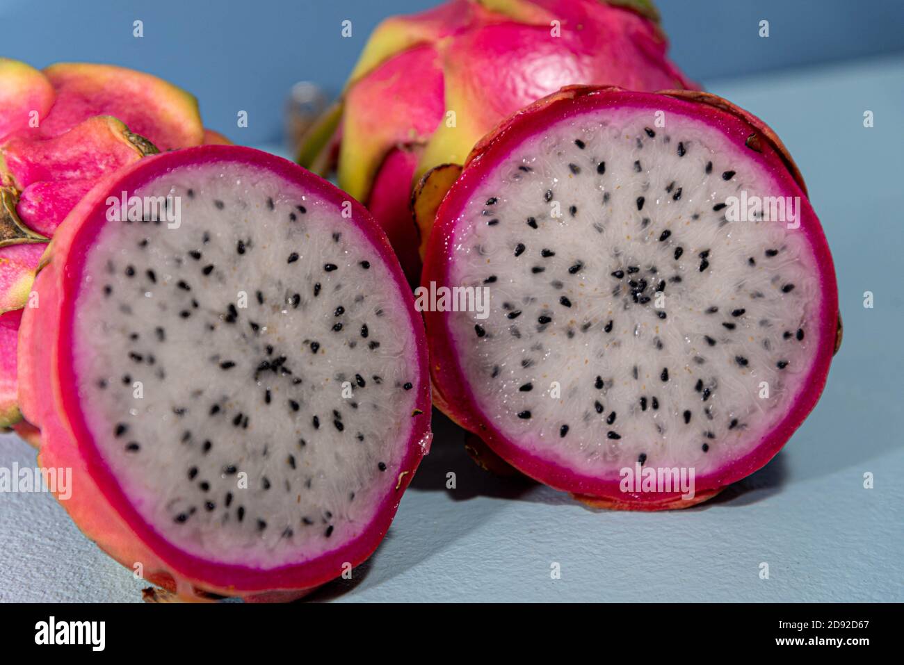 Pitaya fruits. Dragon fruit in halves. Blue background. Natural and ...