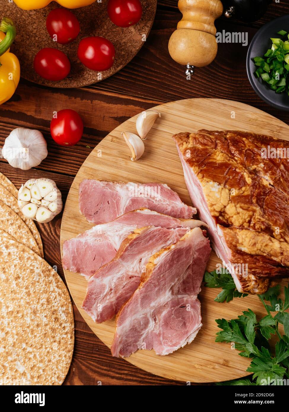 ham sliced on a background with vegetables and spices Stock Photo - Alamy