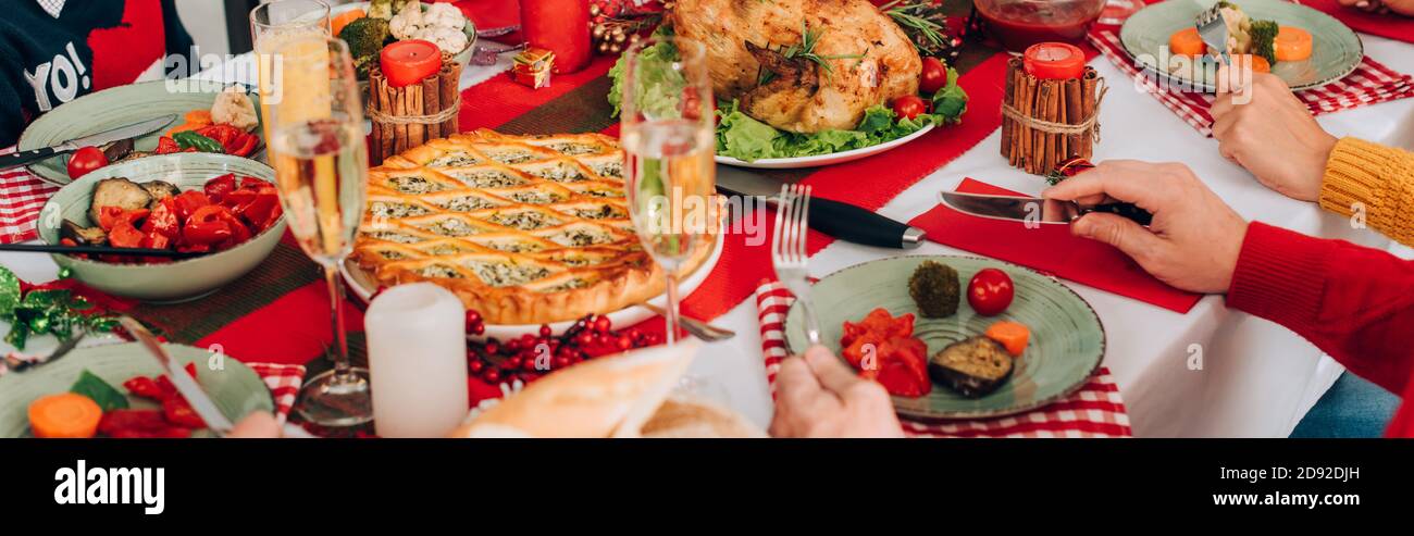 Panoramic shot of family sitting at festive table with thanksgiving ...