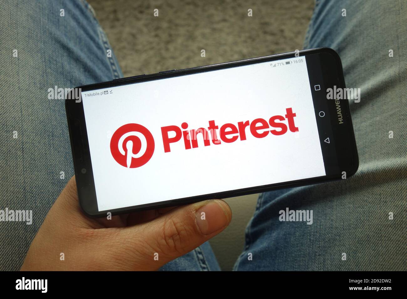 Man holding smartphone with Pinterest mobile application company logo ...