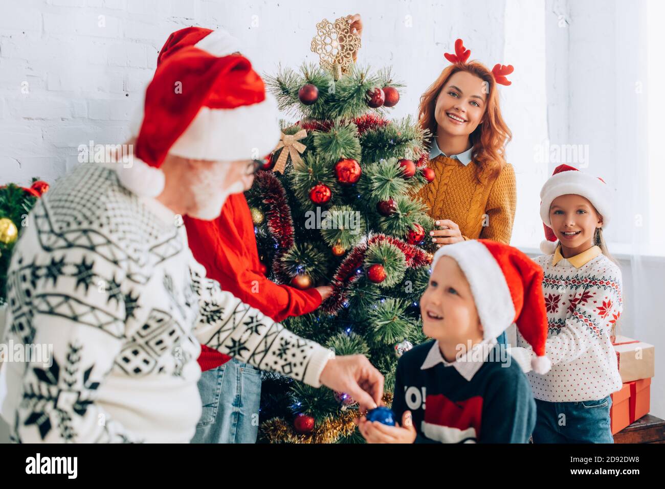 selective focus of grandfather giving bauble to grandson while ...