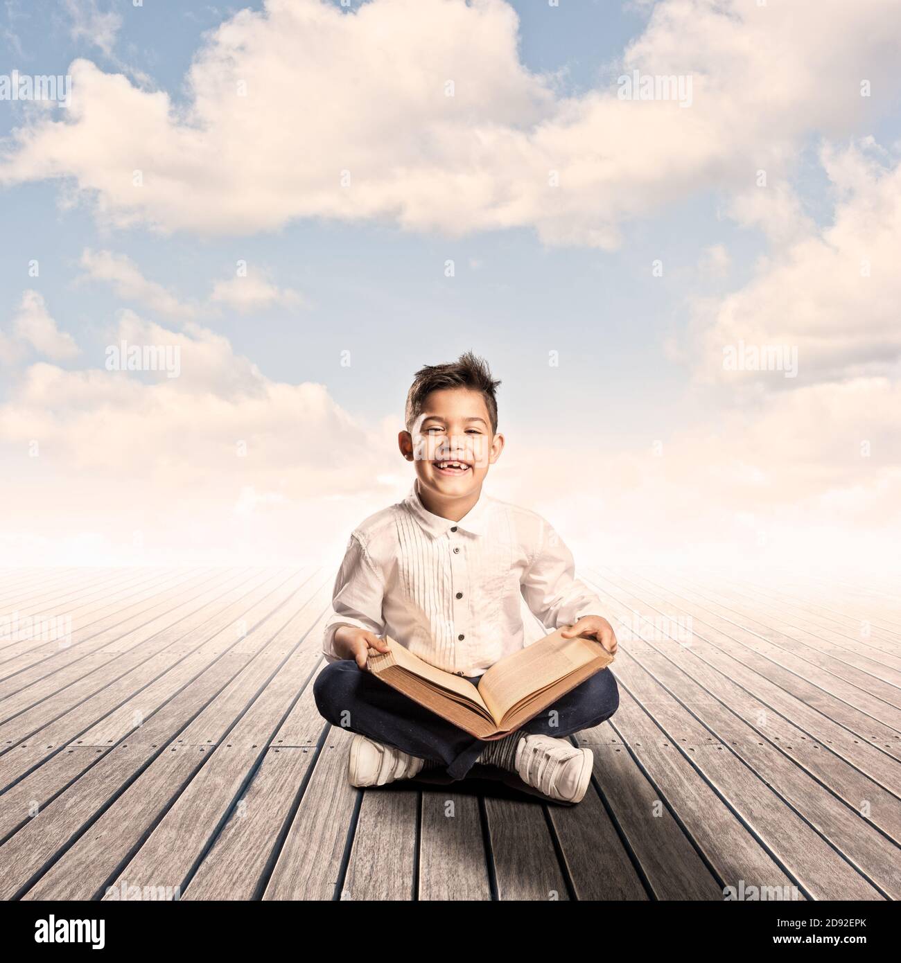 little boy reading a book on a wharf Stock Photo - Alamy