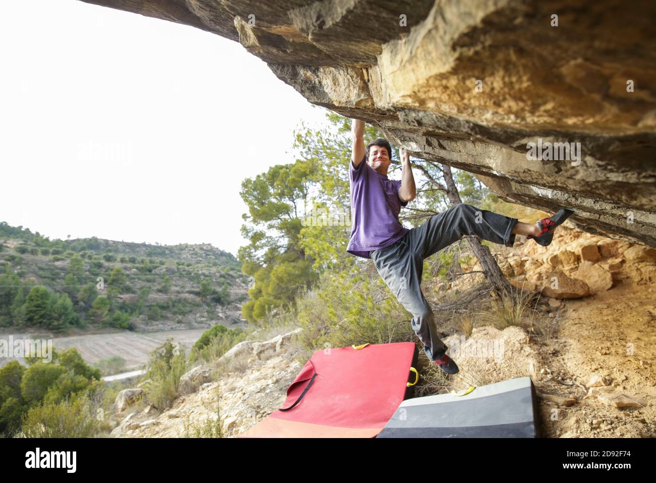 Male Rock Climber Cuts his foot on roof boulder Stock Photo - Alamy