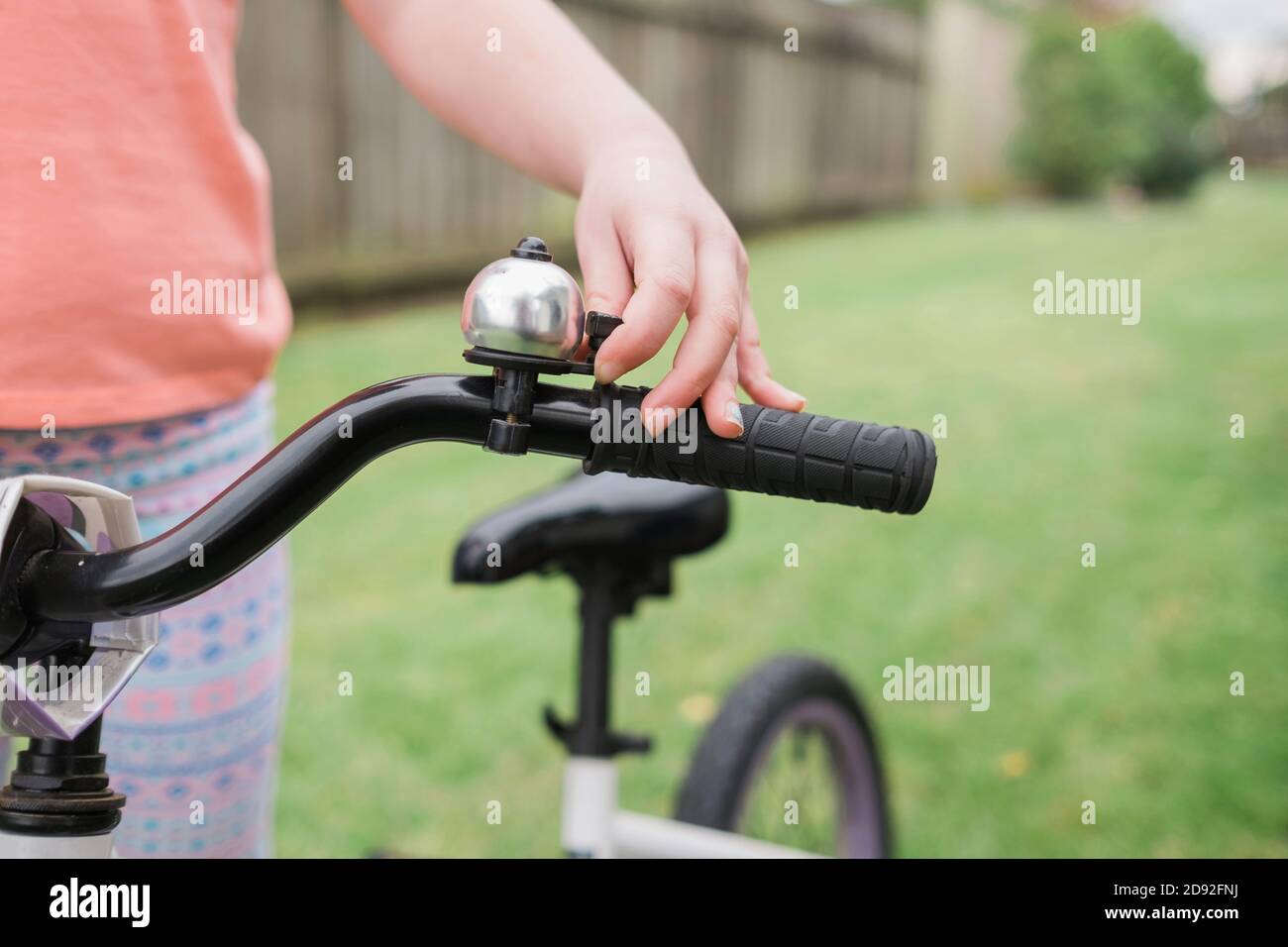 Closeup of a young girl ringing bell on bicycle Stock Photo - Alamy