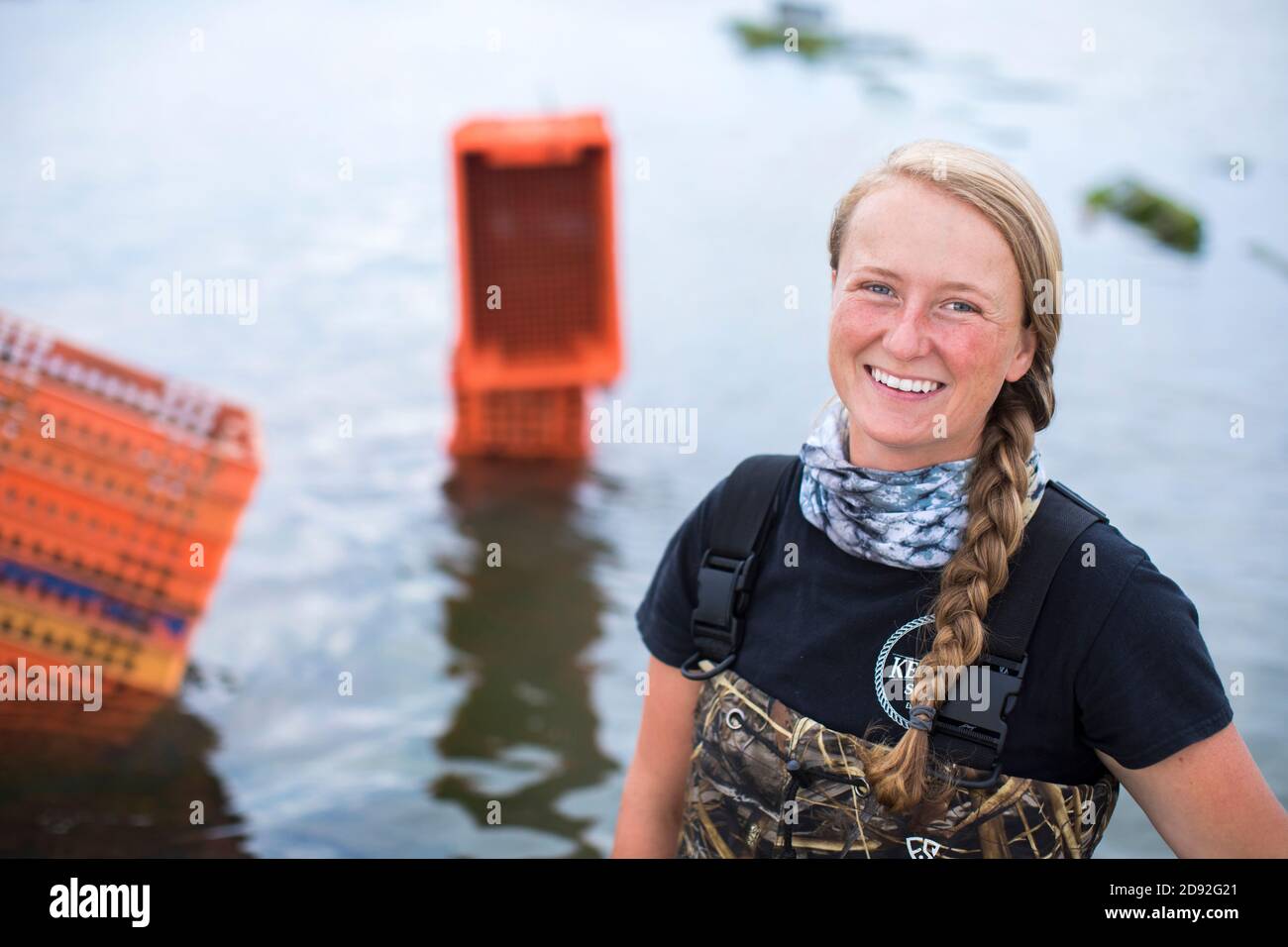 portrait of female shellfish farmer standing in water Stock Photo - Alamy