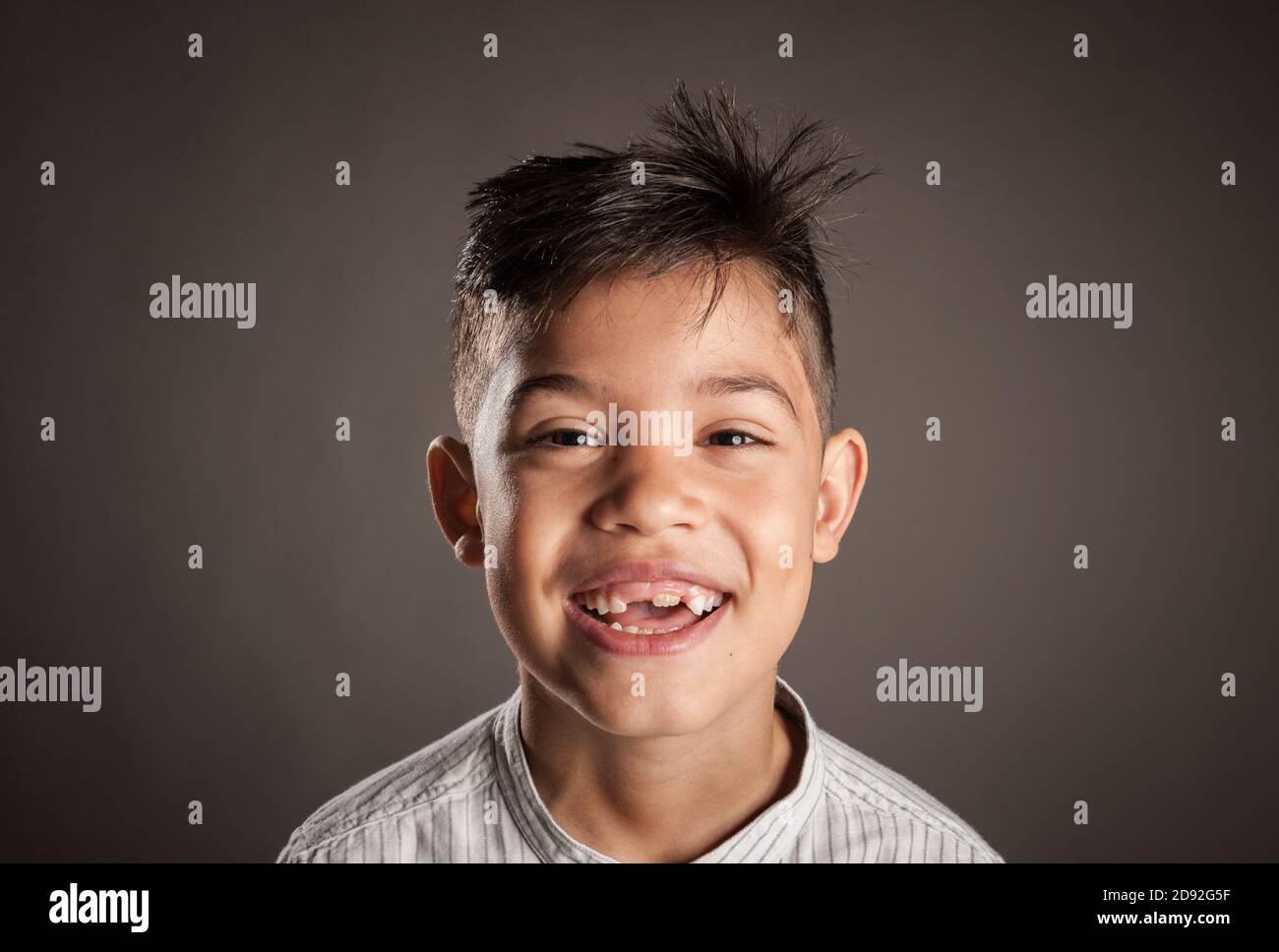 portrait of happy kid smiling on a grey background Stock Photo - Alamy