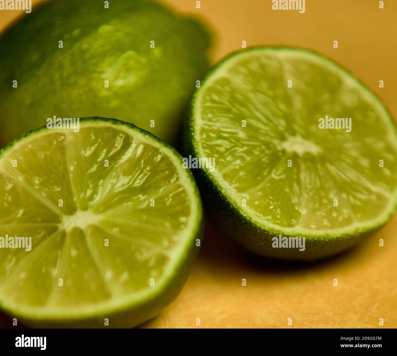 Limes on Yellow Backgropund Stock Photo - Alamy