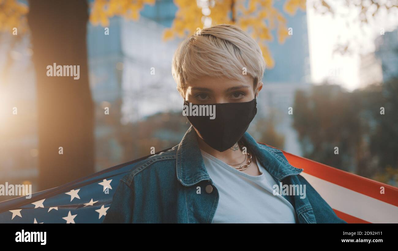 USA presidential election concept. Confident young woman with face mask ...