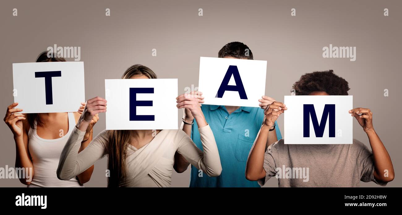 group of people holding banners with team word written Stock Photo - Alamy