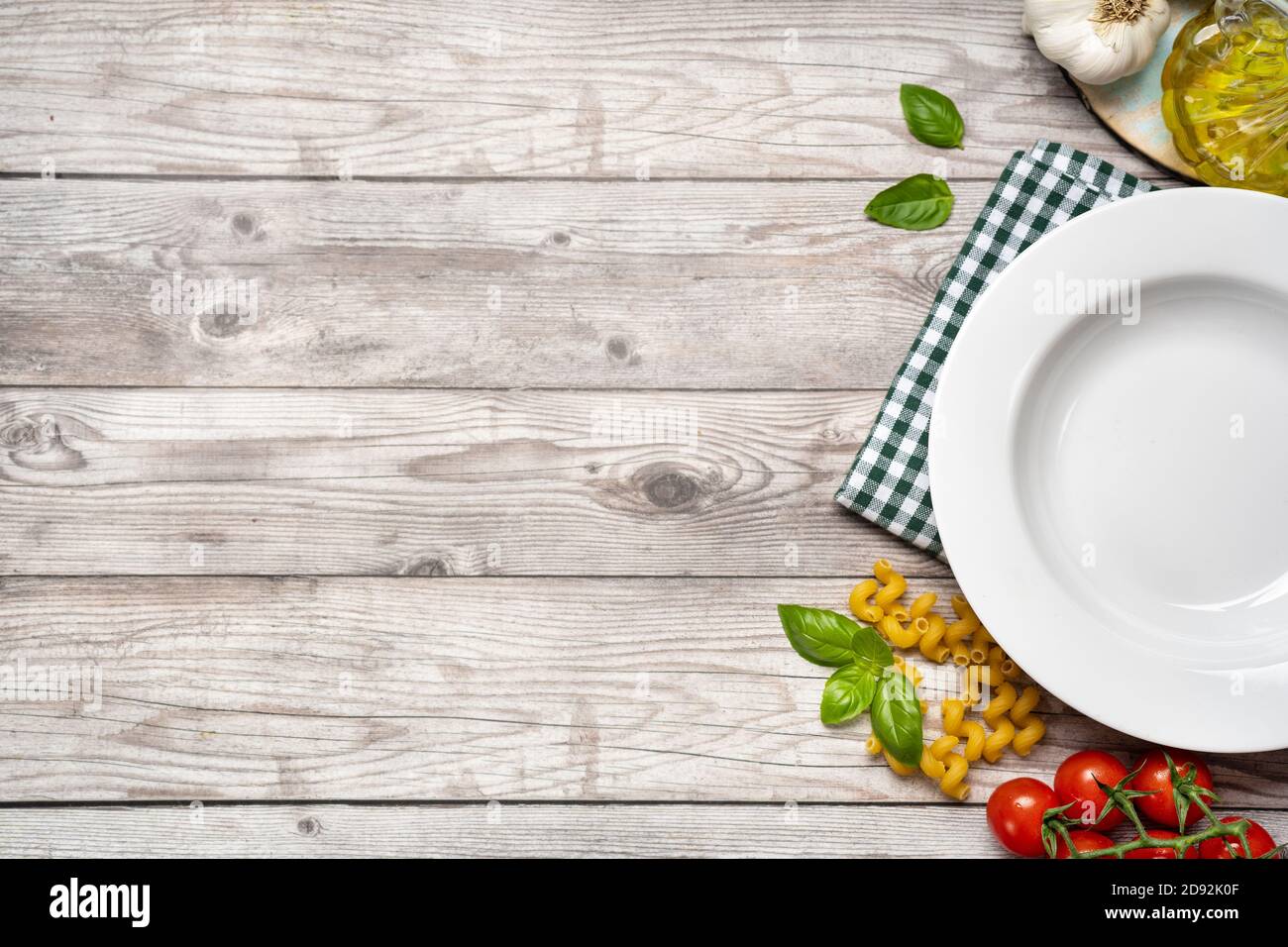 Food cooking background with vegetables, pasta and empty white plate ...