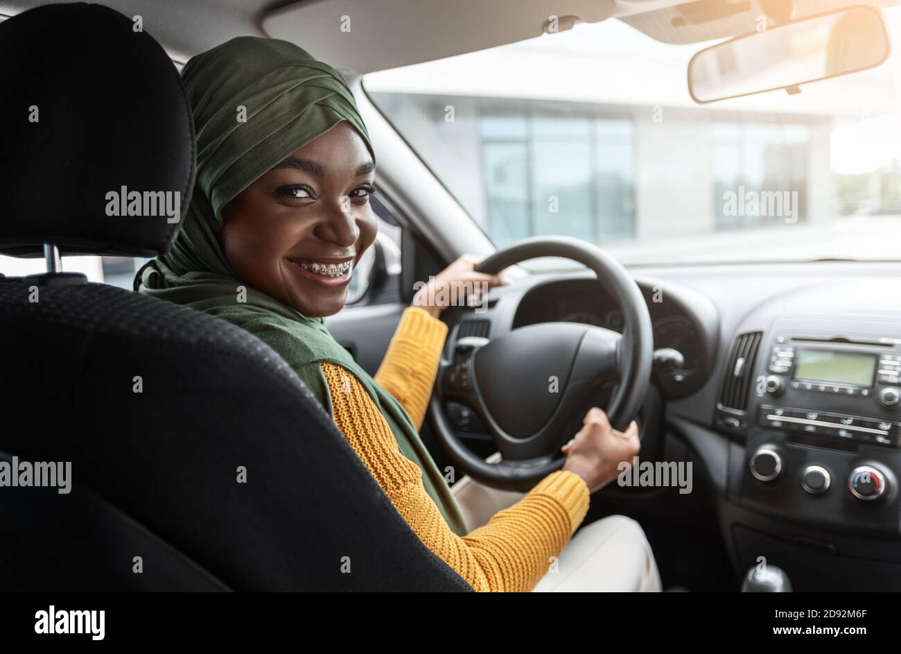 Buying Automobile. Smiling Black Muslim Lady In Hijab Testing New Car ...