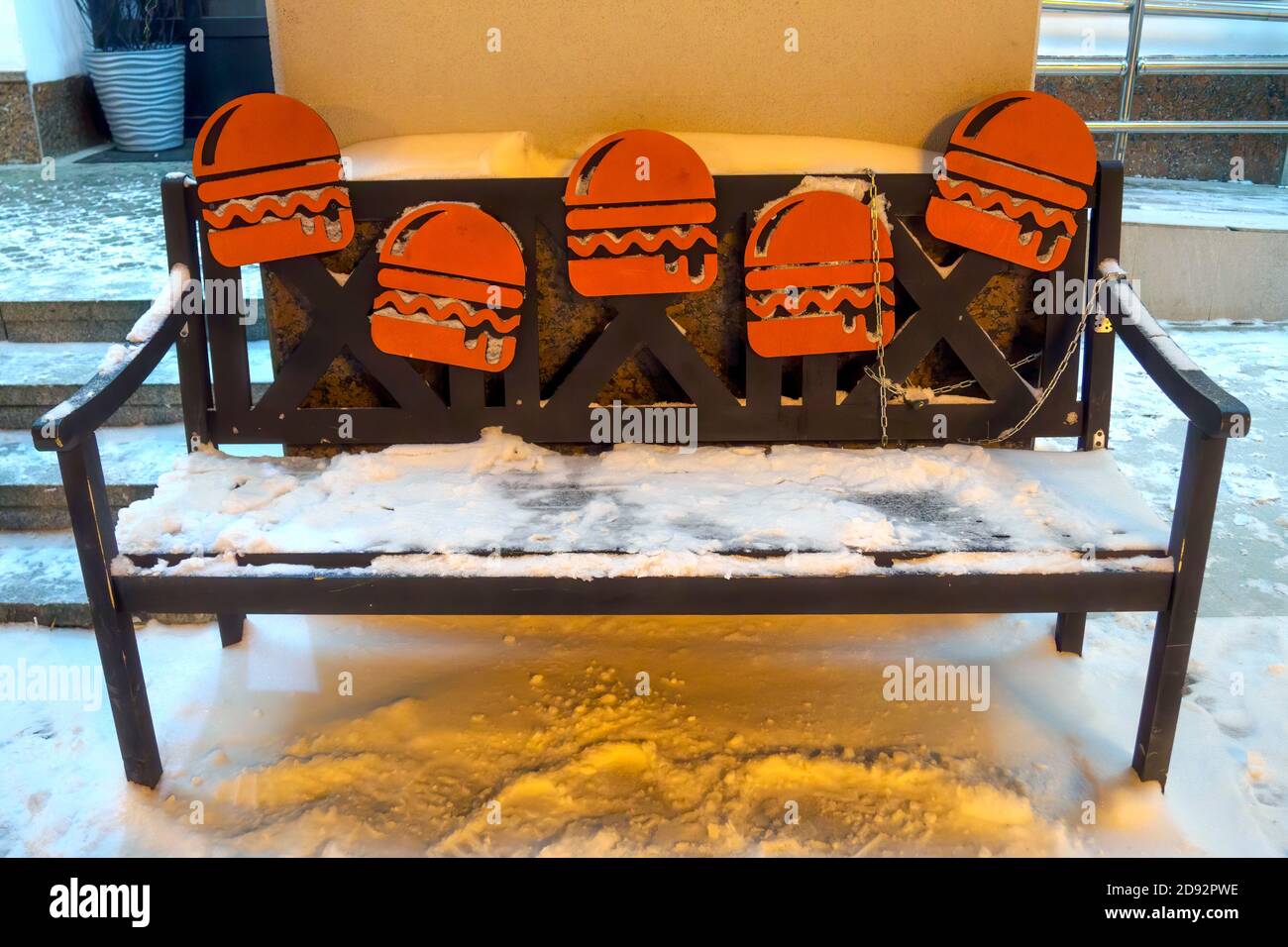 Brown wooden bench decorated with red sandwich-shaped badges in the ...
