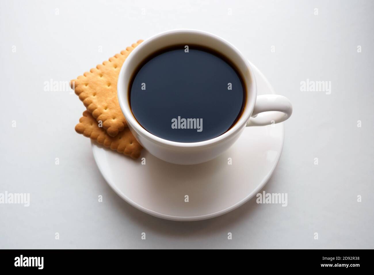 Cup of black coffee with crackers on saucer on white background Stock ...