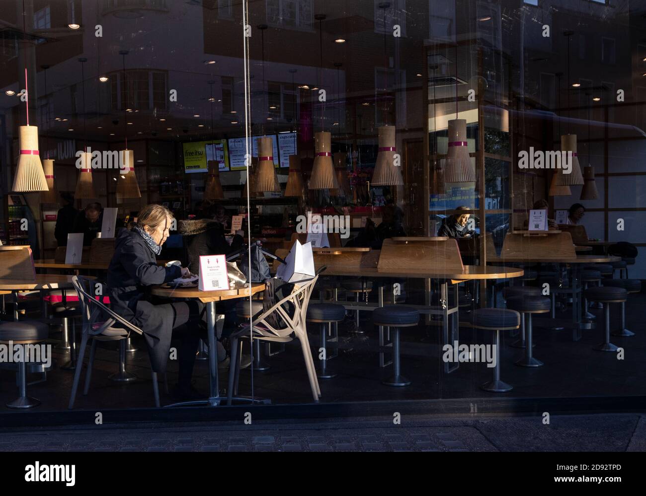 A woman eats alone in an ITSU restaurant on one of the last days before ...