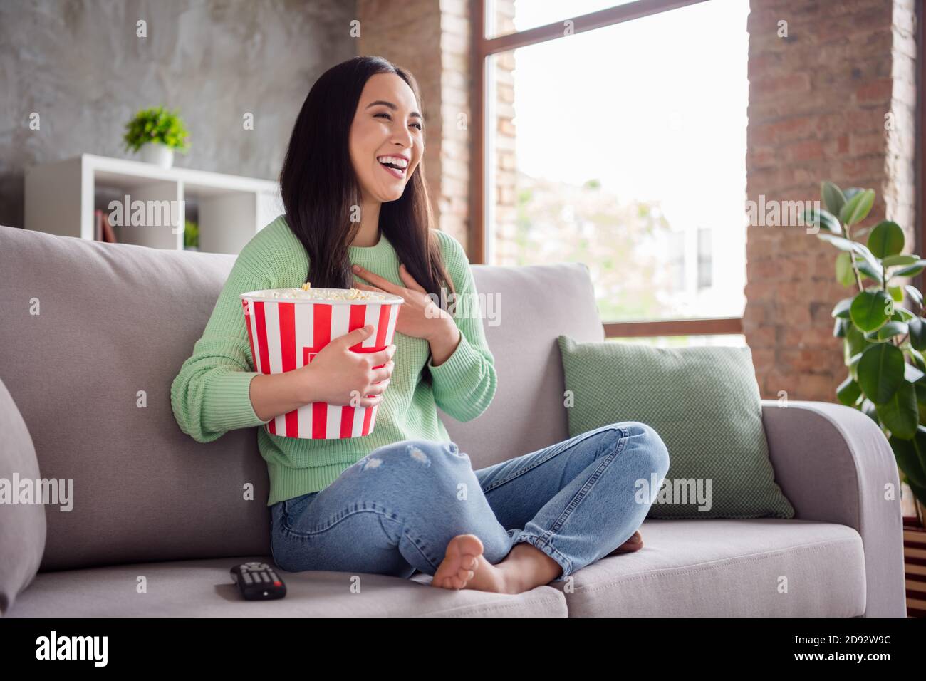 Profile side full length photo candid lovely korean girl sit divan legs ...