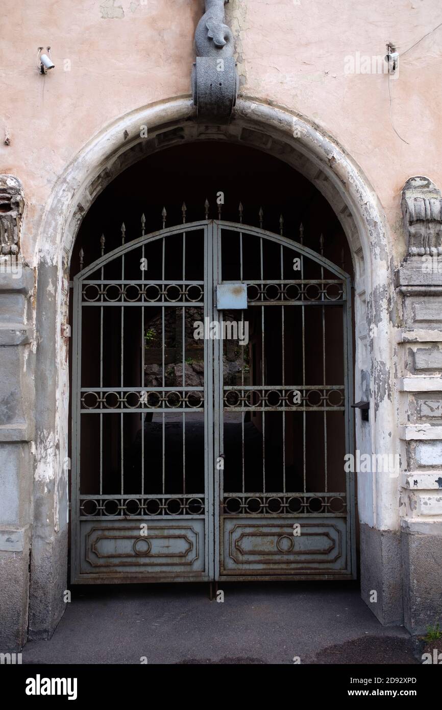 an old gateway with an iron gate. vertical frame Stock Photo - Alamy