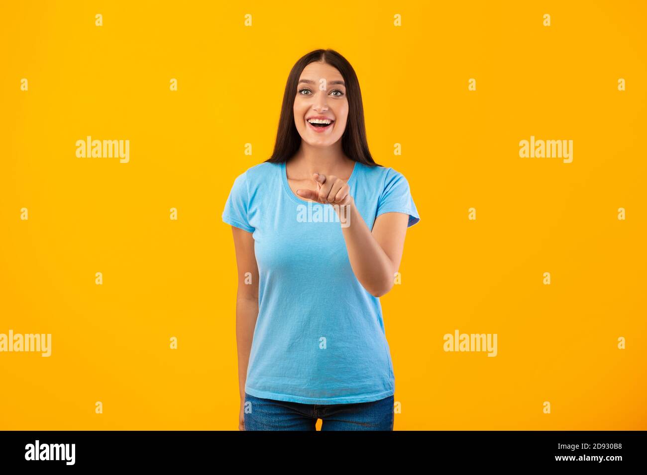 Happy female pointing finger at camera at studio Stock Photo - Alamy