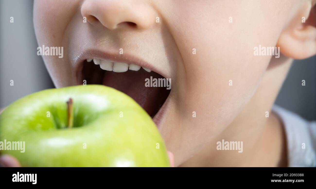 children's teeth bite a green Apple. healthy teeth and care Stock Photo ...