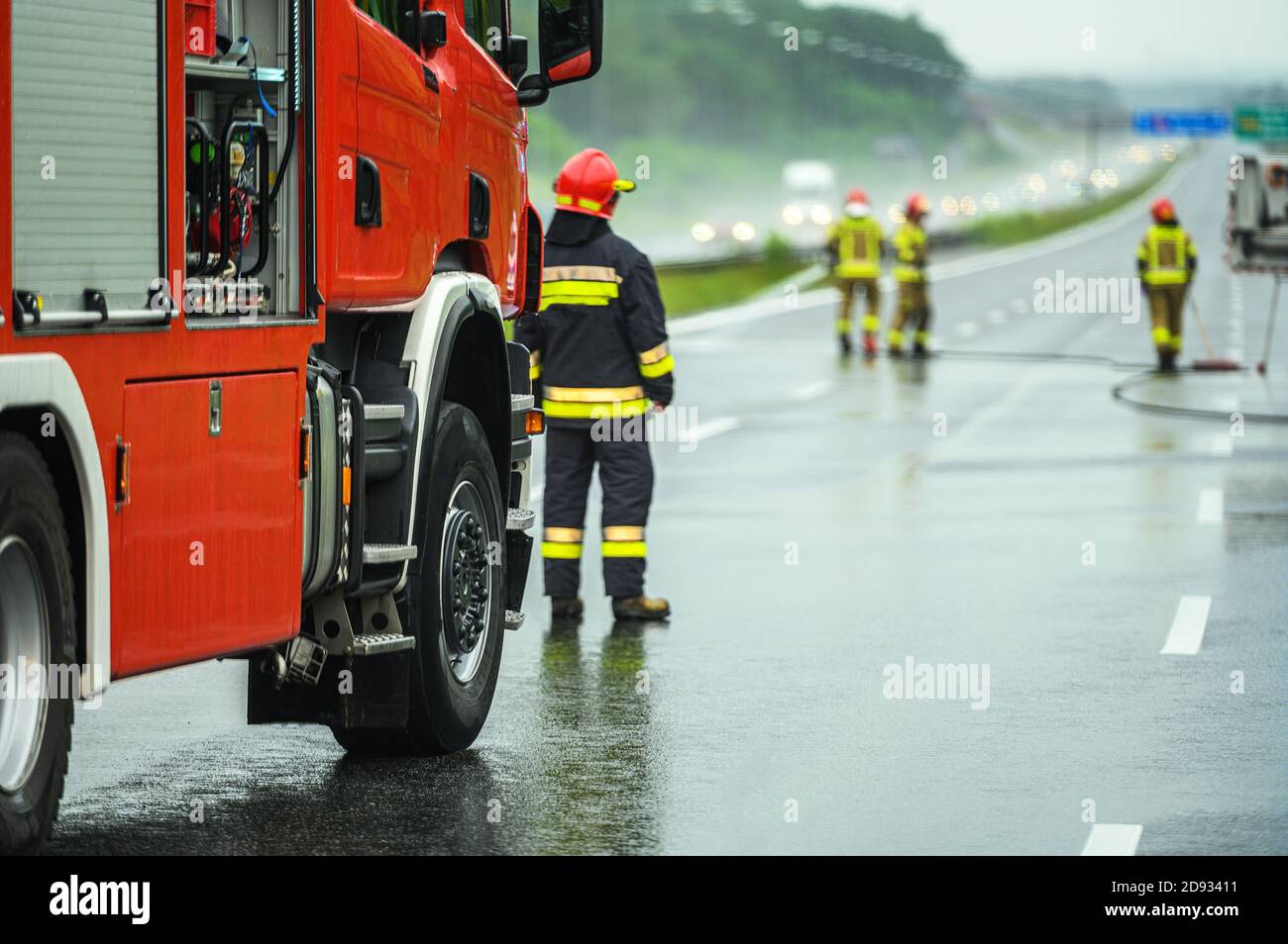 Traffic Accident Emergency Fire Crew on the Highway. Rainy Weather Poor ...