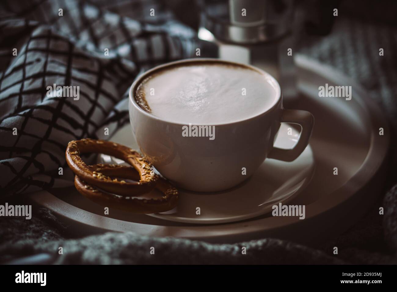 Cup of coffee on tray in cozy winter bad with wool blanket Stock Photo ...