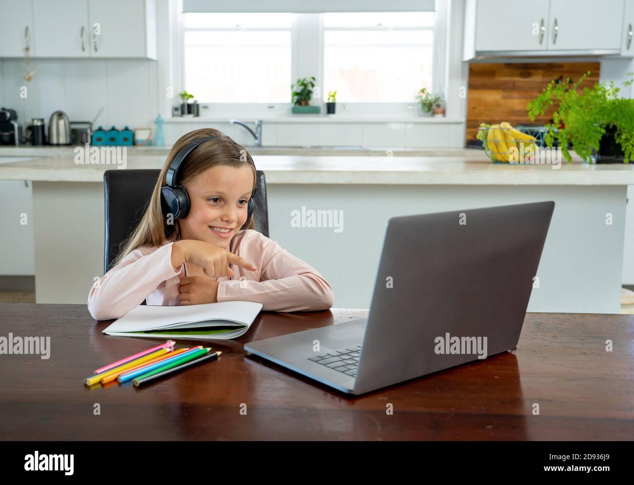 Happy Schoolgirl on laptop watching online lesson learning remotely at ...
