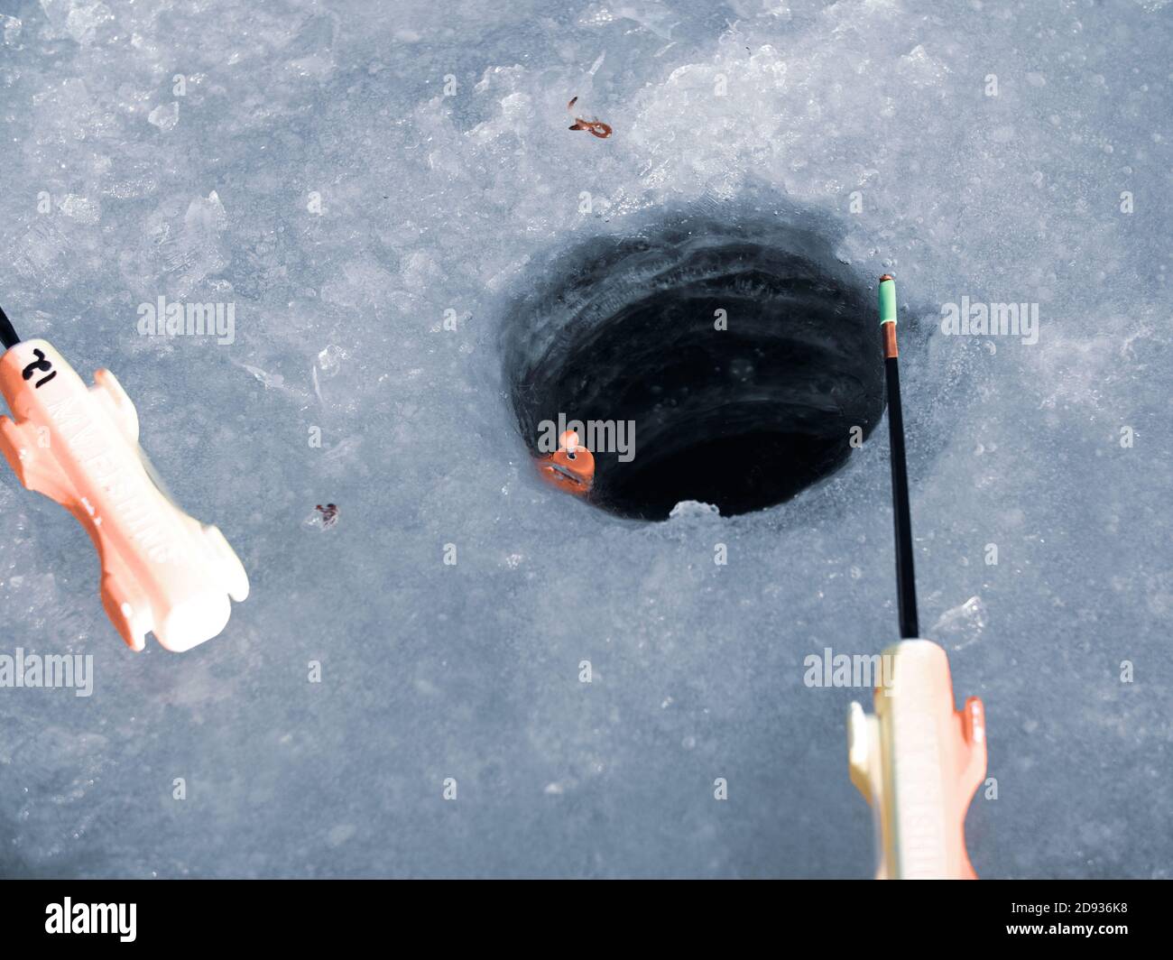 Winter rod on blue ice. Winter fishing background. Fishing rod and ice ...