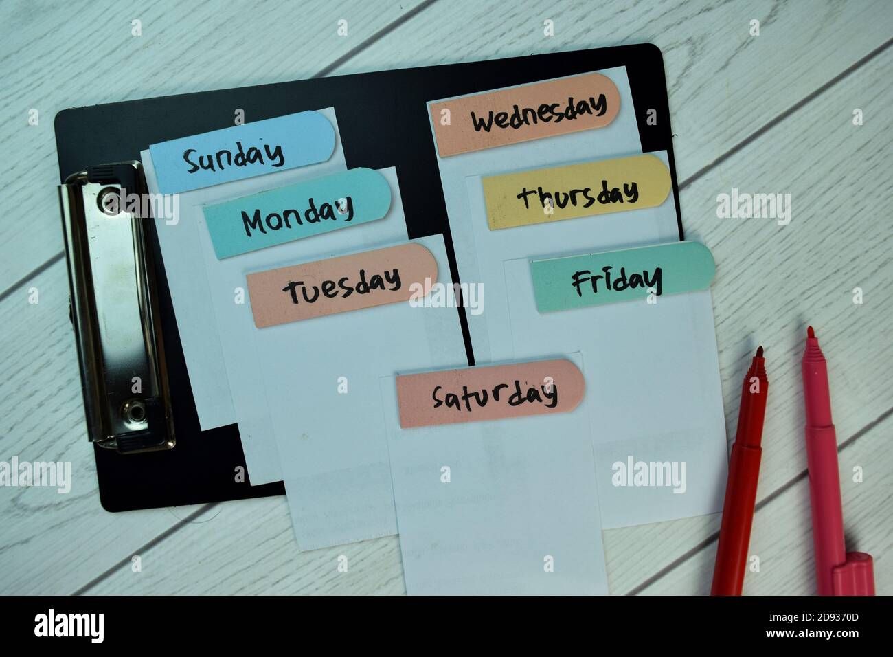 The Day of the week write on sticky notes isolated on Wooden Table ...