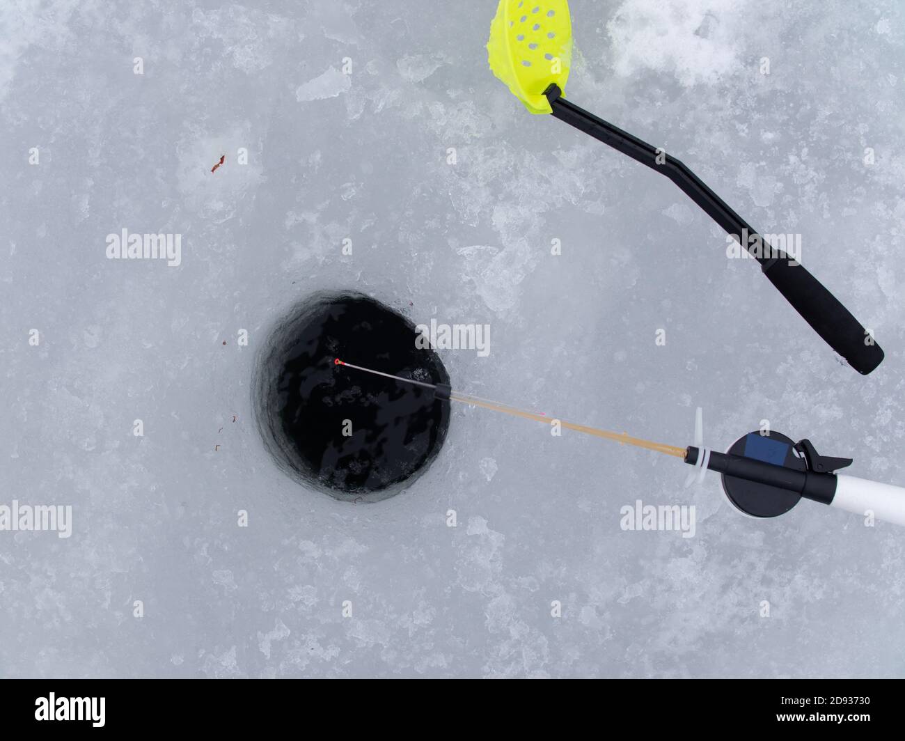 Winter fishing. Fishing rod stands on the ice. Fishing theme Stock ...