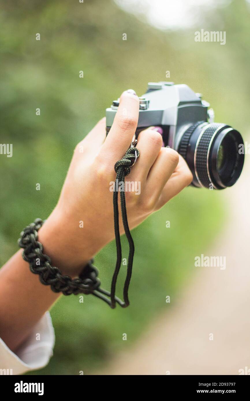 Vertical selective focus shot of a female hand holding a camera Stock ...