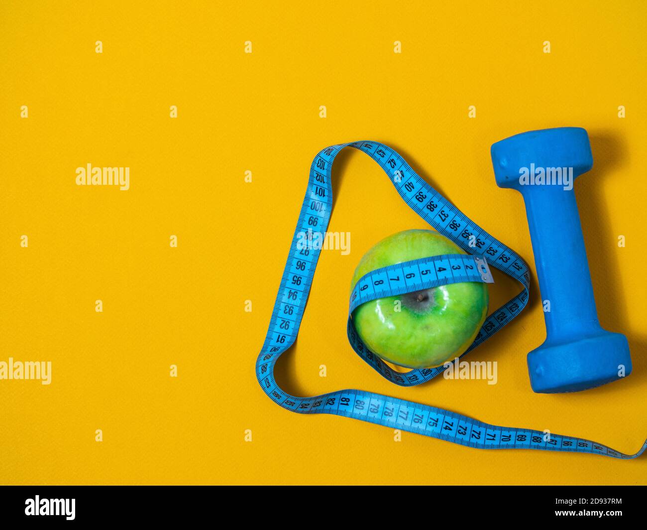 flat lay photo of fitness equipment over turquoise yellow backgound ...